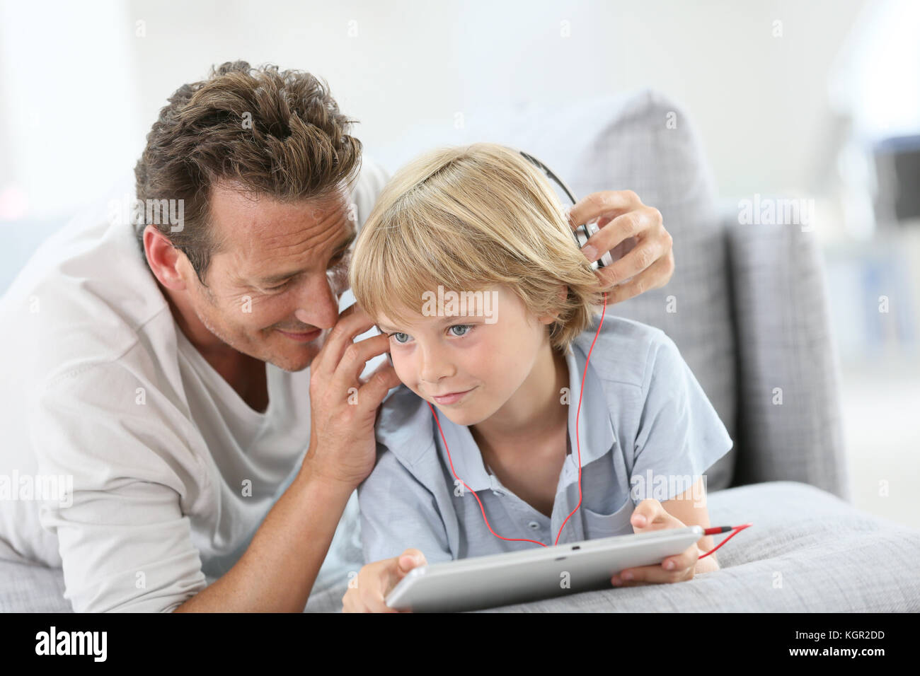 Father and son listening to music on tablet Stock Photo - Alamy