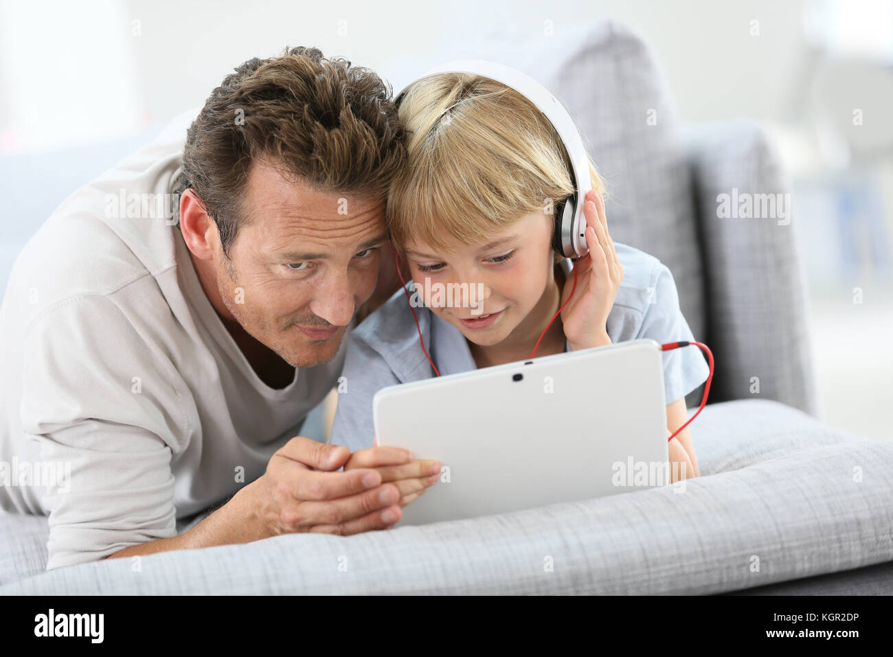 Father and son listening to music on tablet Stock Photo - Alamy