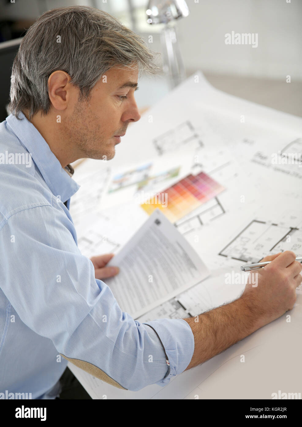 Architect working on construction project in office Stock Photo - Alamy