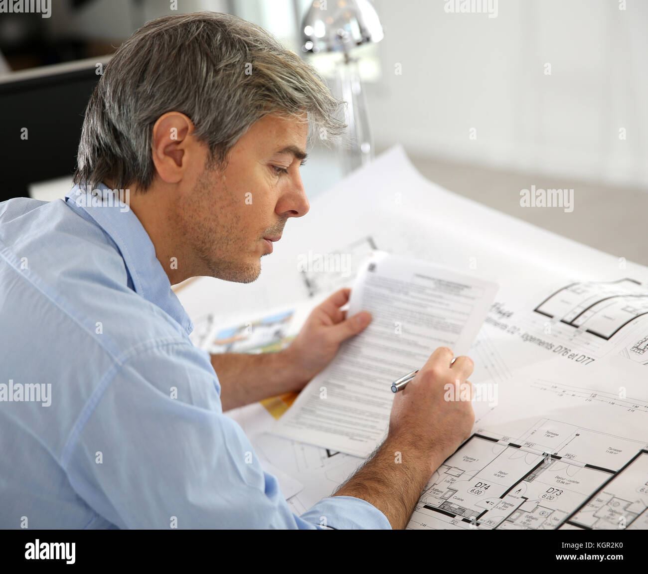 Architect working on construction project in office Stock Photo - Alamy