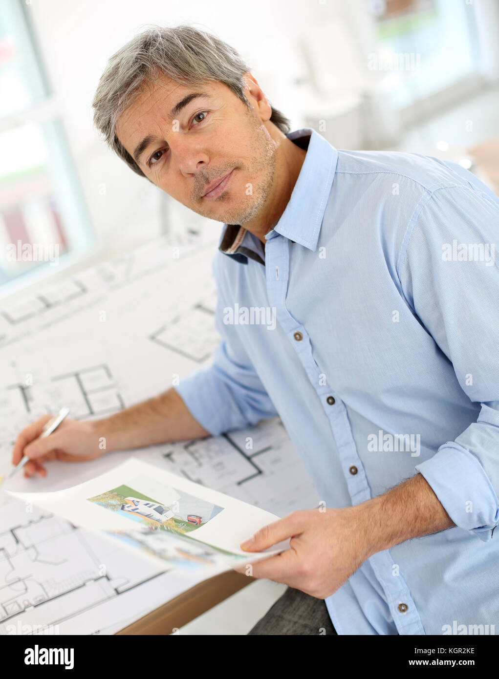 Architect designing house for client Stock Photo - Alamy