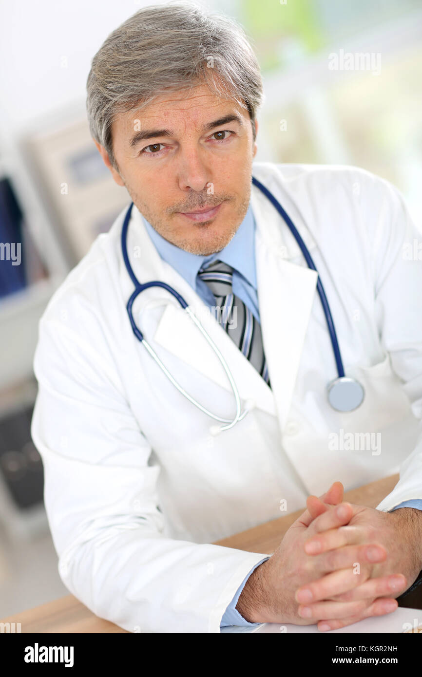 Portrait of attractive senior doctor Stock Photo - Alamy
