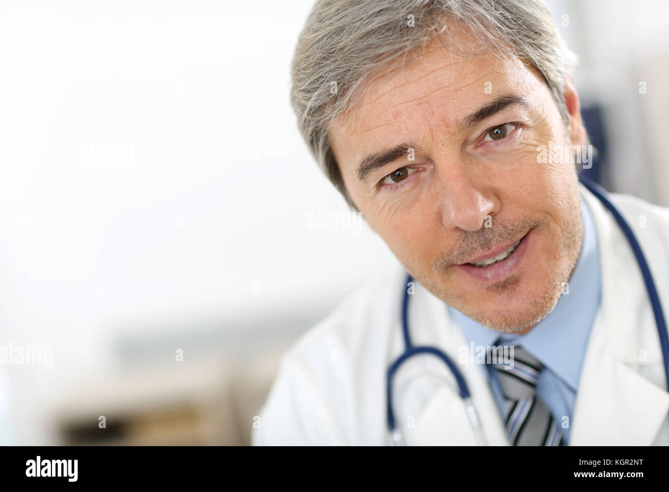Portrait of attractive senior doctor Stock Photo - Alamy