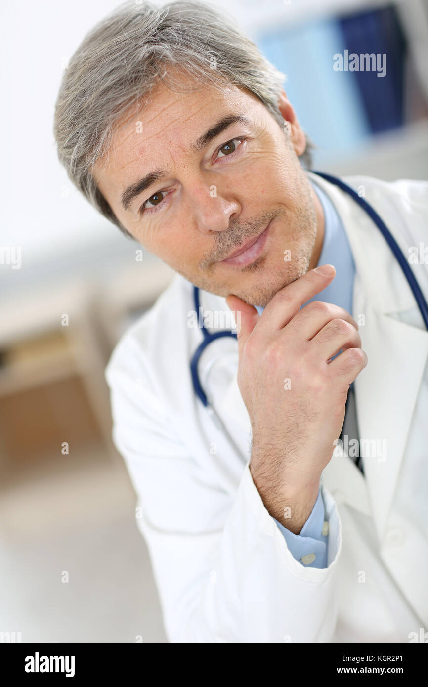 Portrait of attractive senior doctor Stock Photo - Alamy