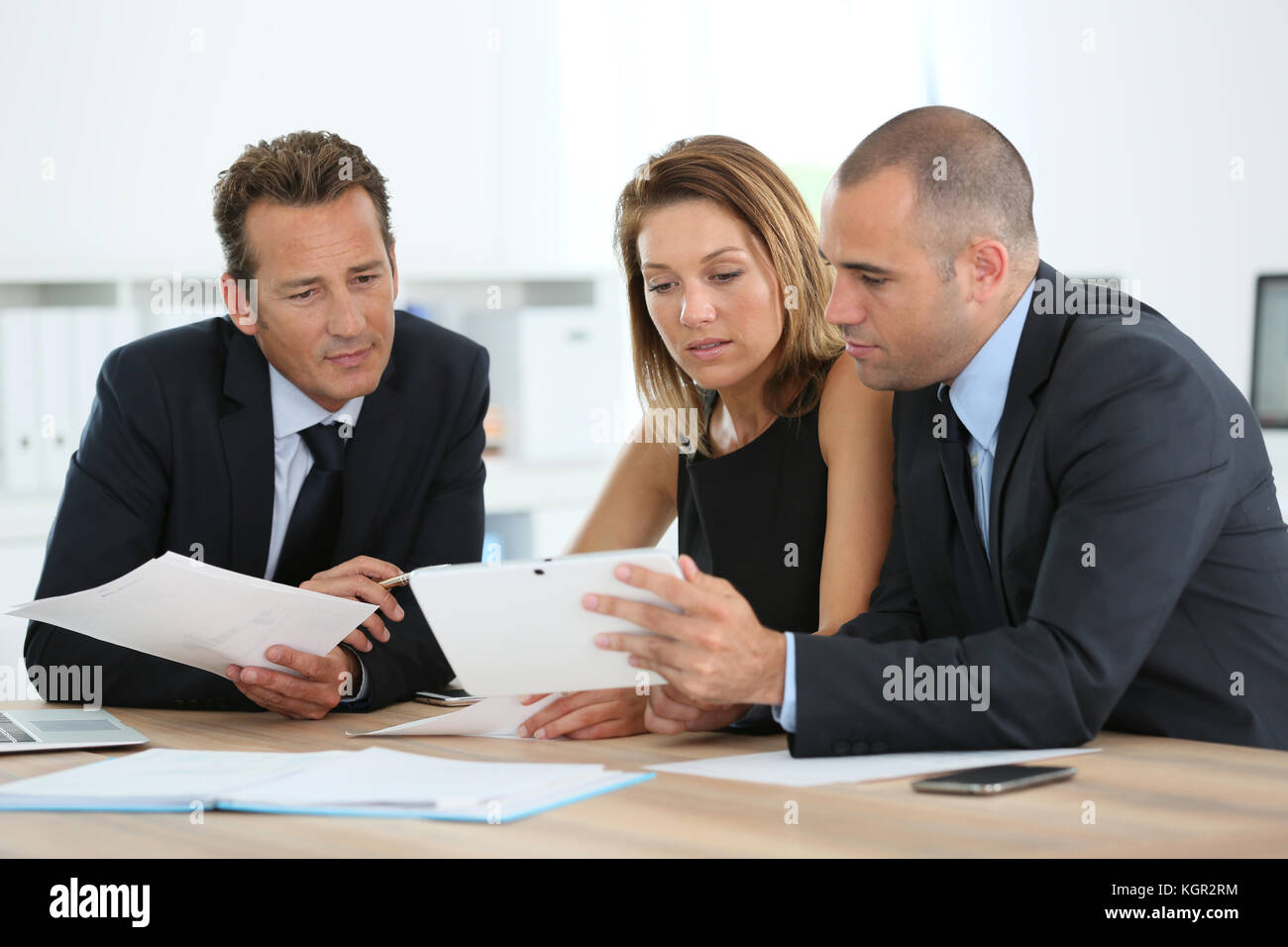 Manager with sales team meeting in office Stock Photo - Alamy