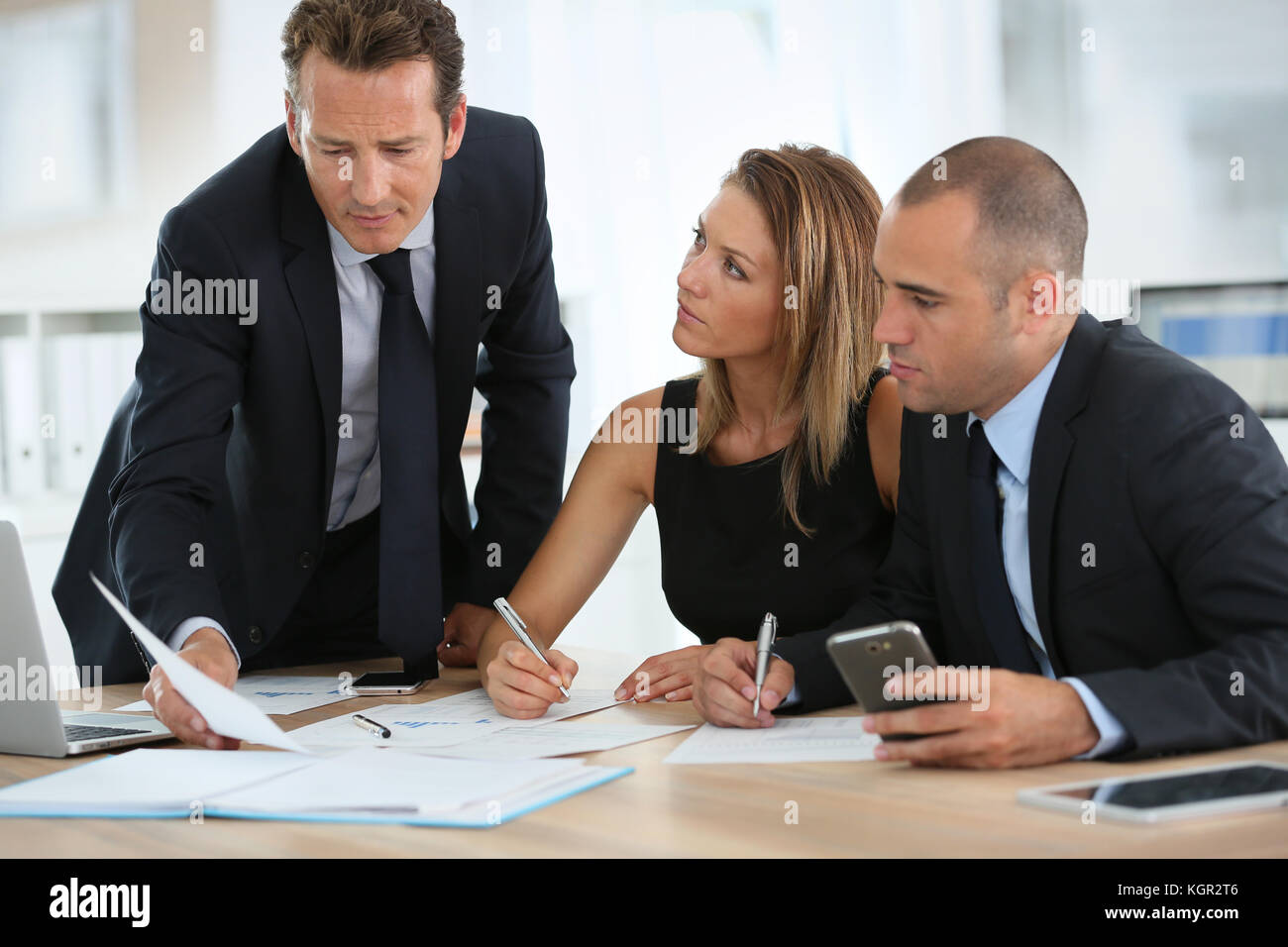 Business people looking at budget forecast Stock Photo - Alamy