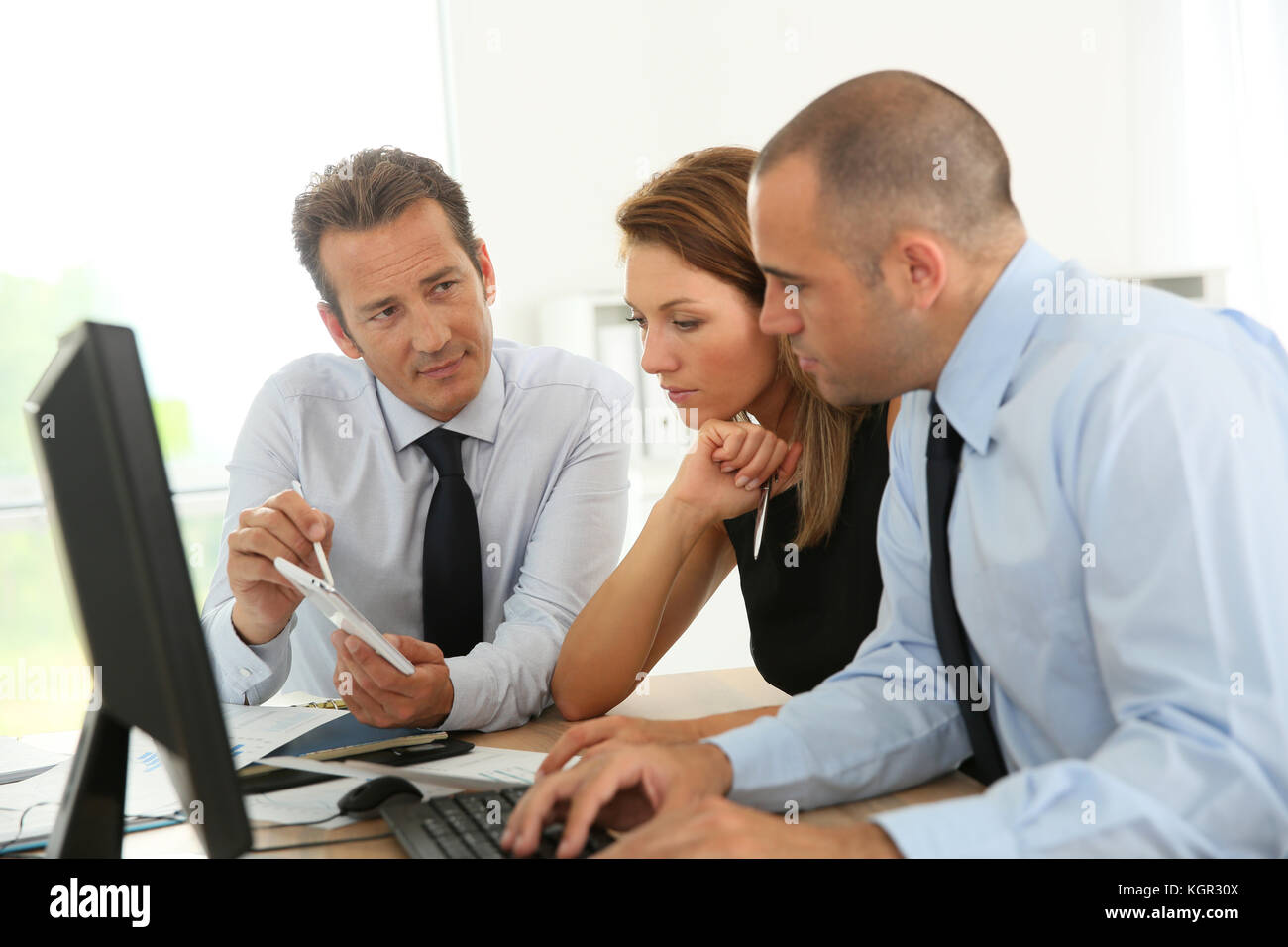 Business people working on desktop computer Stock Photo - Alamy