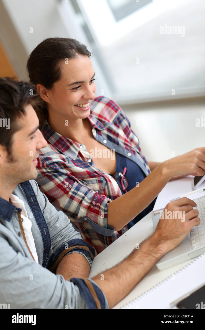 Young people working on laptop computer Stock Photo - Alamy