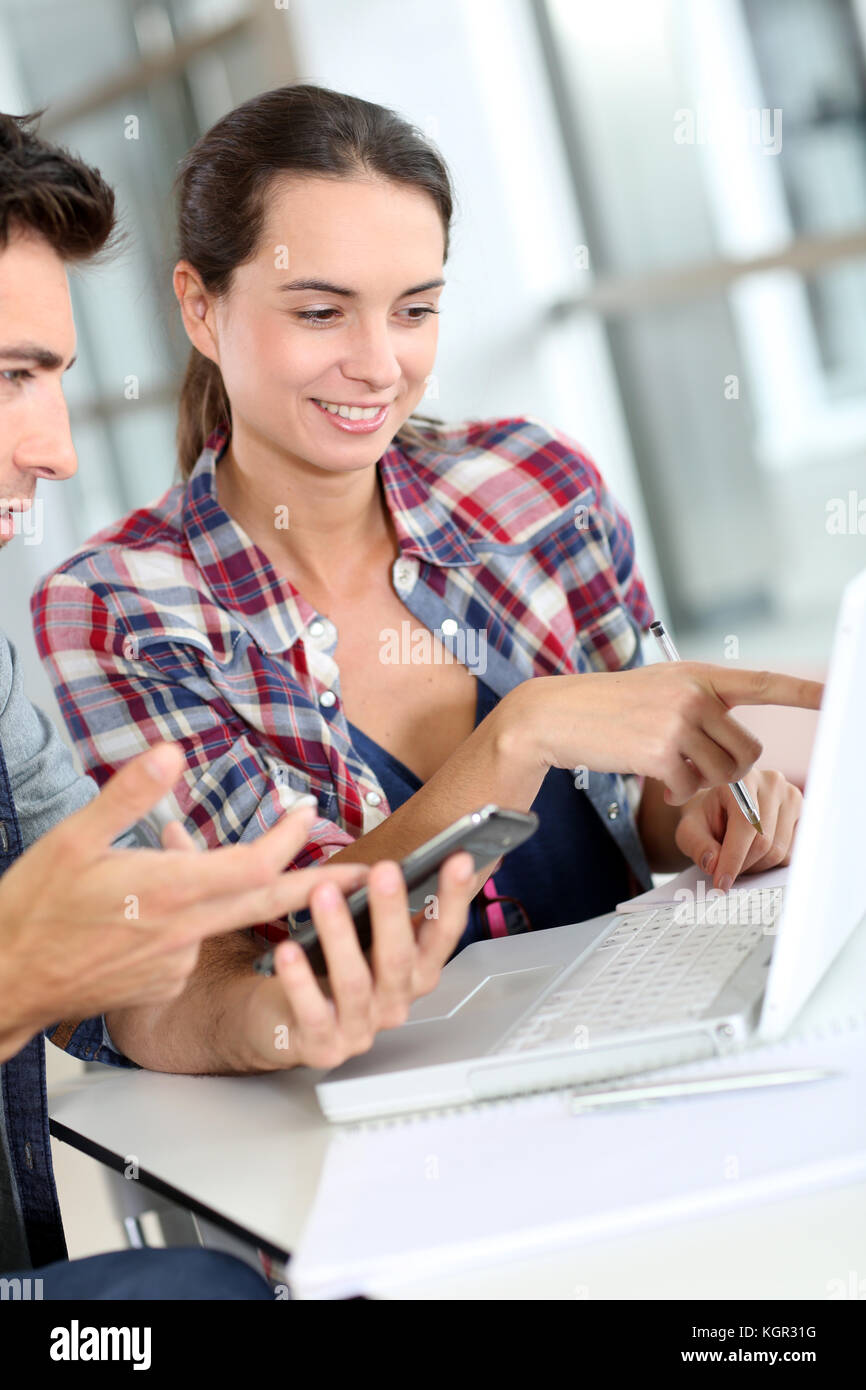 Young people working on laptop computer Stock Photo - Alamy