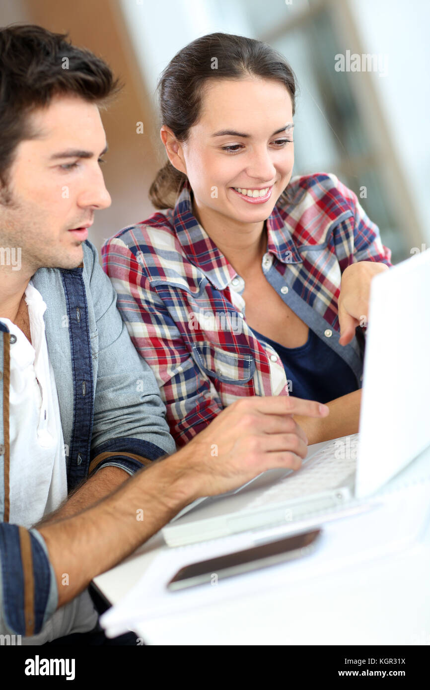 Young people working on laptop computer Stock Photo - Alamy