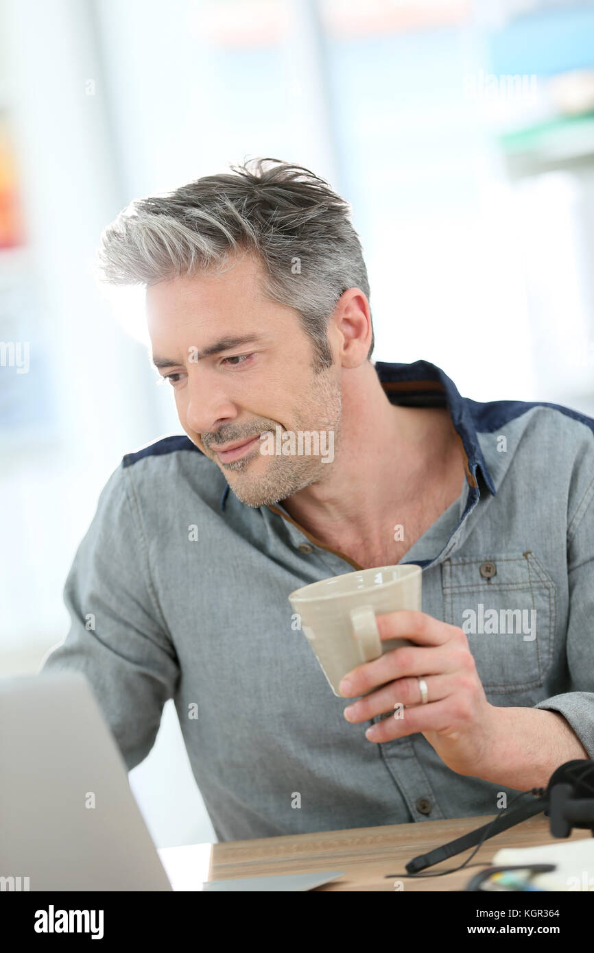 Businessman working form home on laptop computer Stock Photo - Alamy