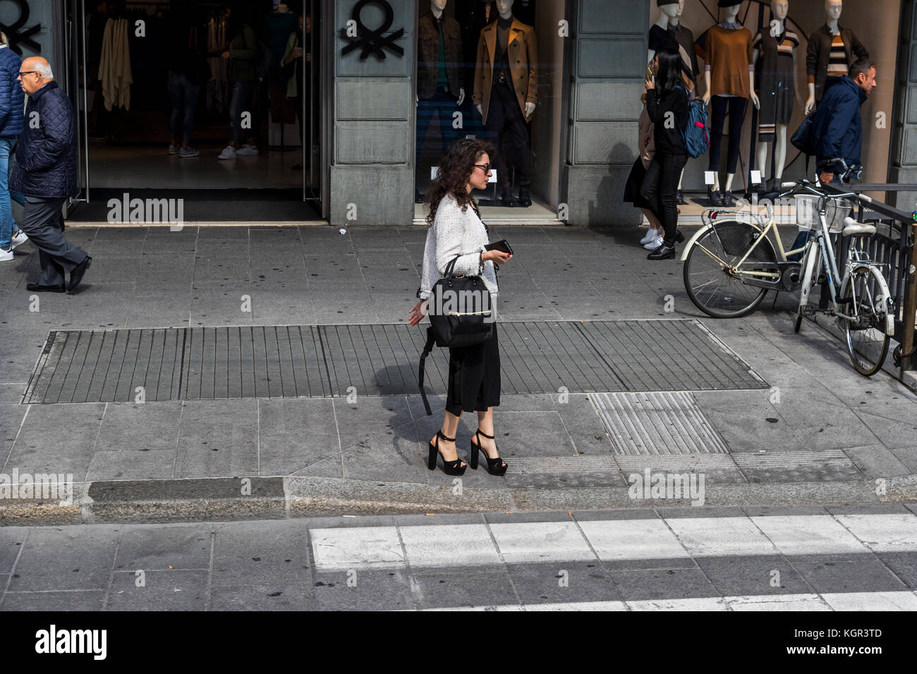 Fashionable Italian women walking in the city. Bologna city life, Italy ...