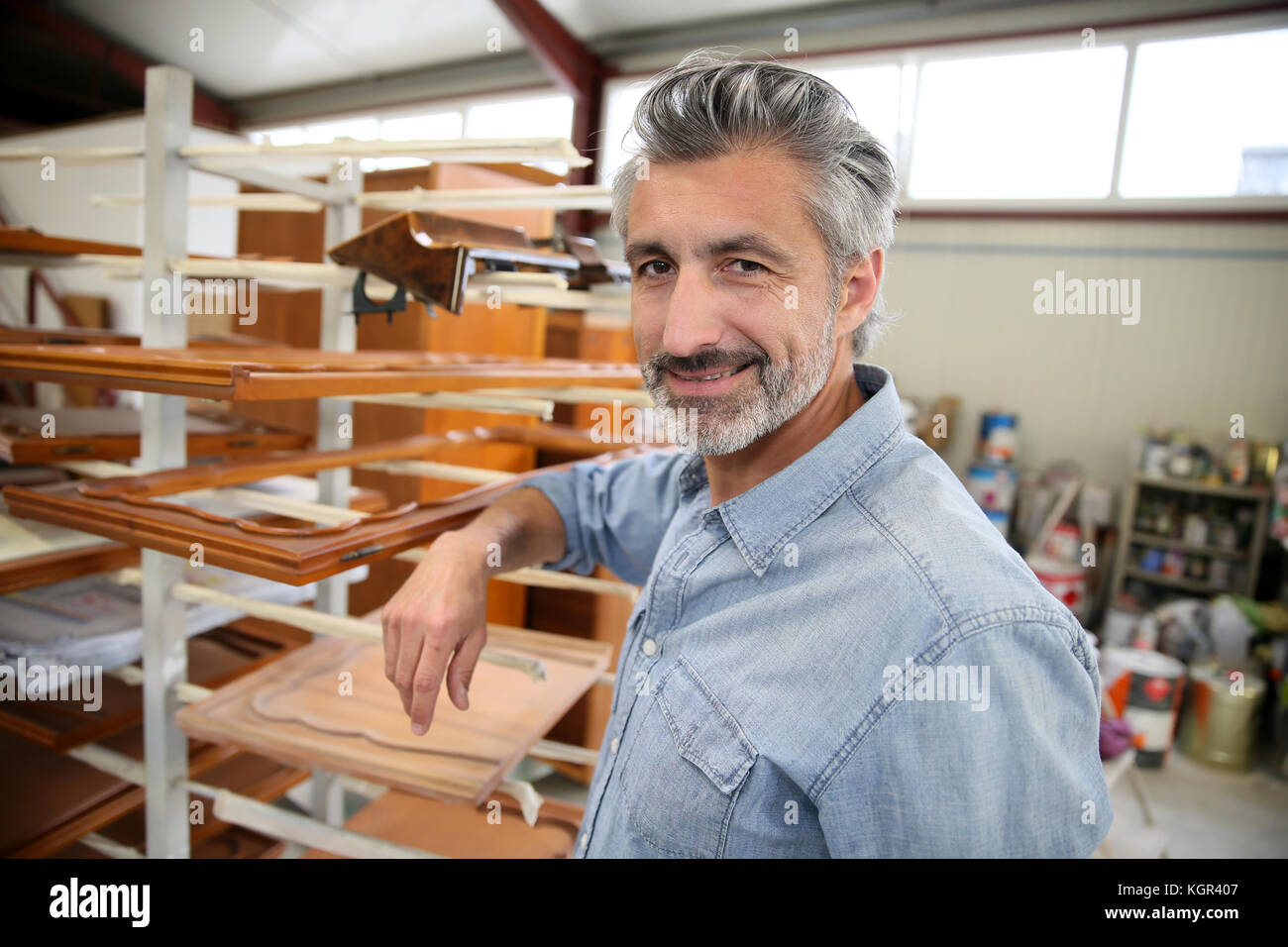 Smiling carpenter standing in workshop Stock Photo - Alamy