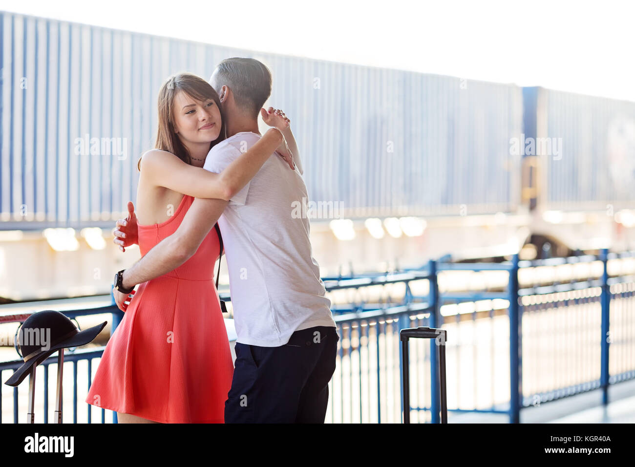 Happy caucasian couple close-up at train station, welcome hug, content ...