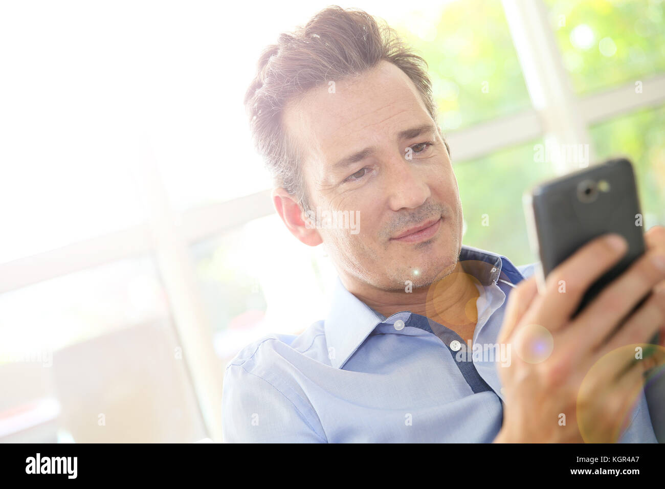 Portrait of middle-aged man using smartphone Stock Photo - Alamy