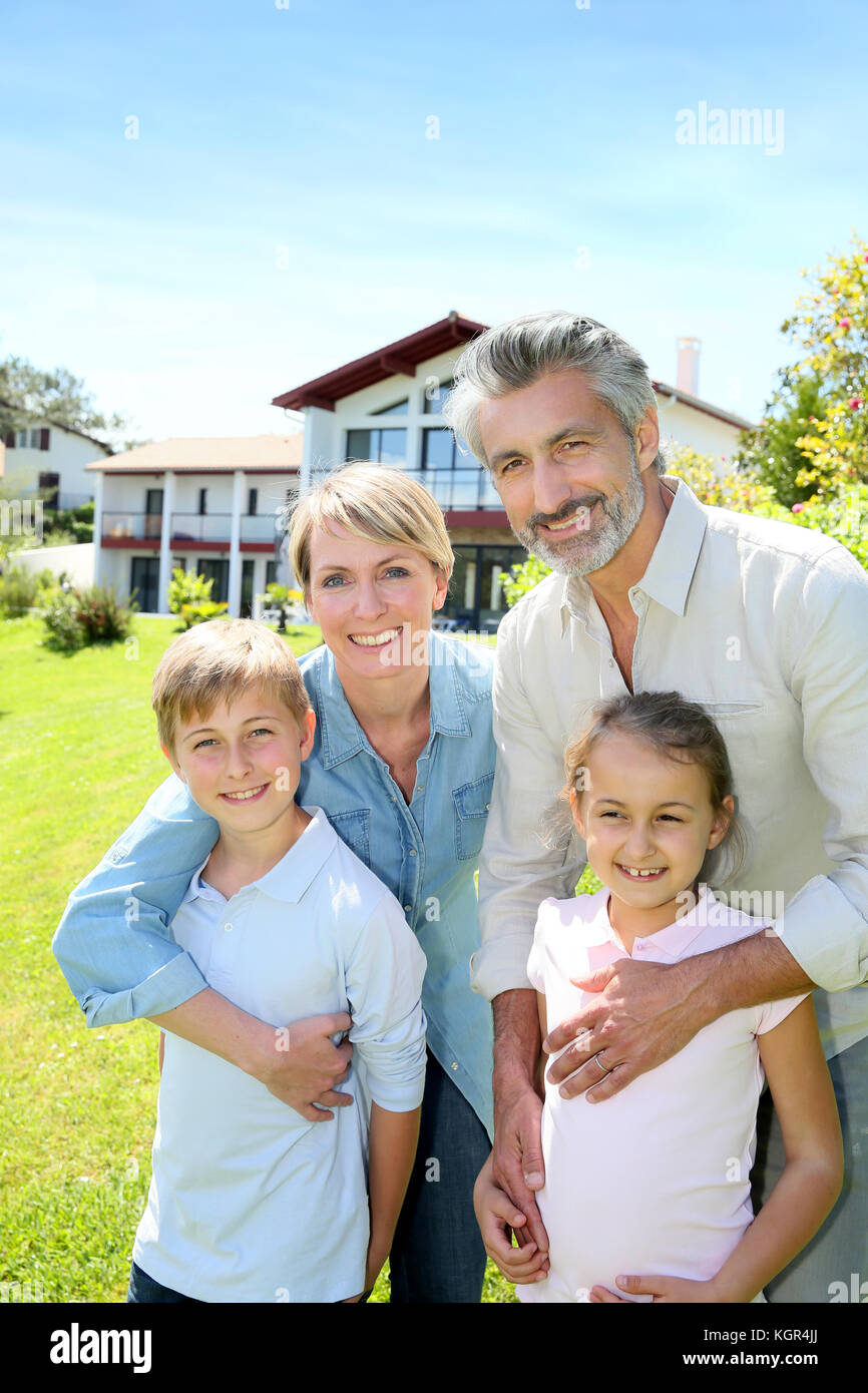 Happy family standing in home private garden Stock Photo - Alamy