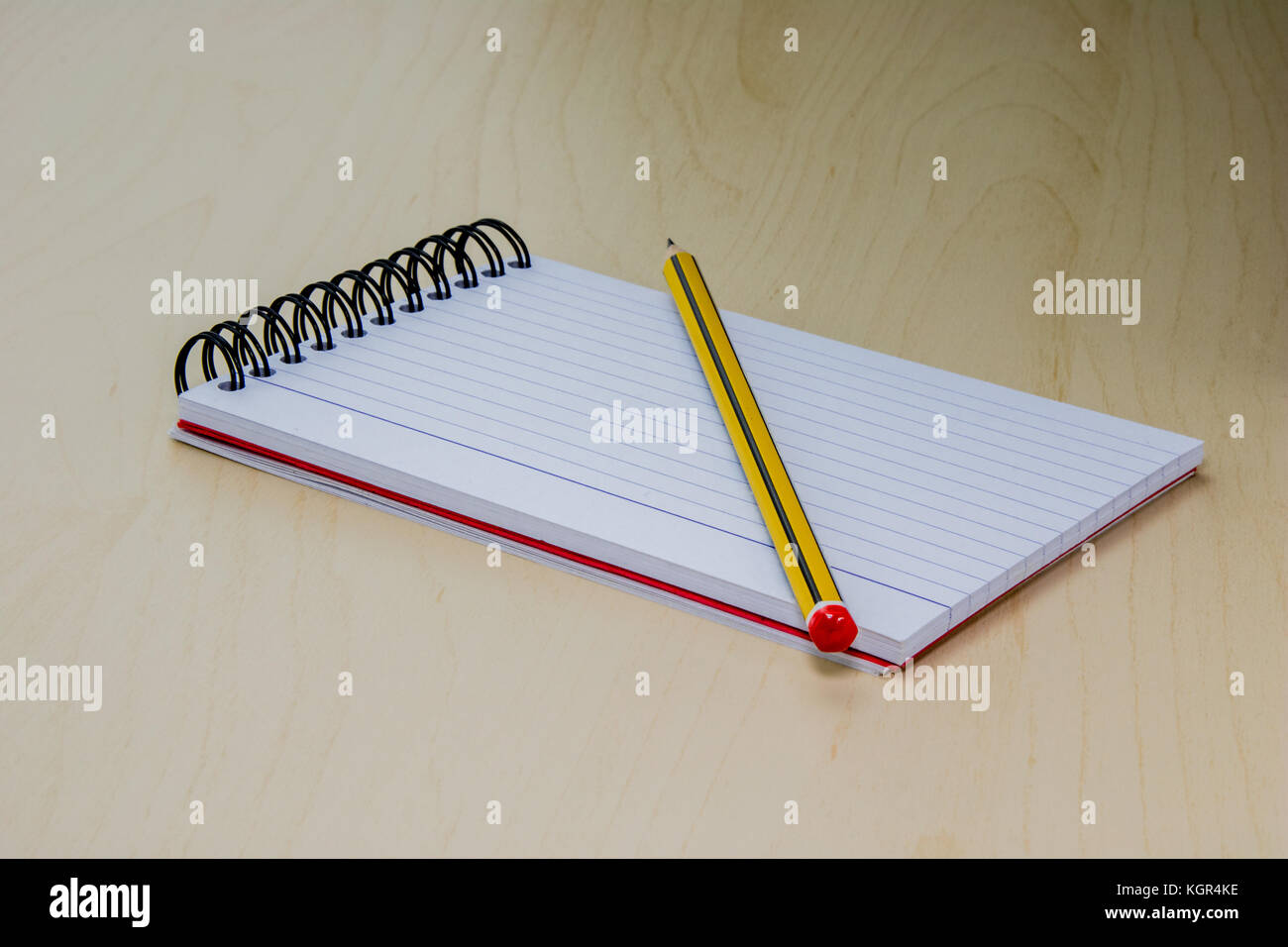 Pencil and notepad on the light wooden table surface Stock Photo - Alamy