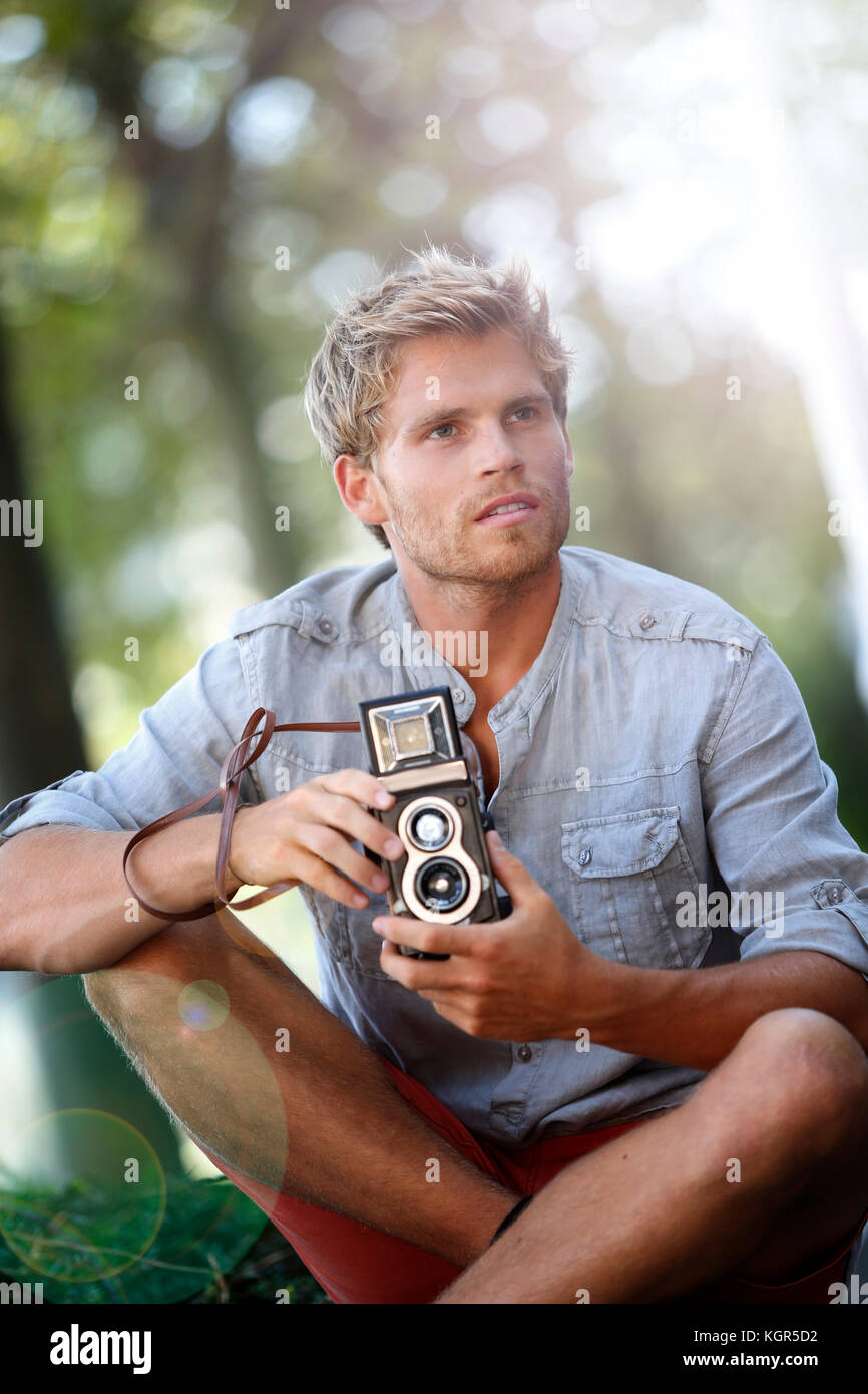 Trendy photographer using vintage camera Stock Photo - Alamy