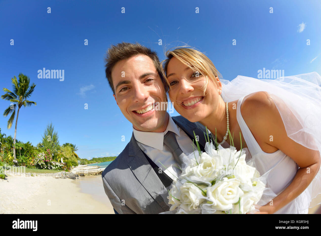 Cheerful couple getting married on the beach Stock Photo - Alamy