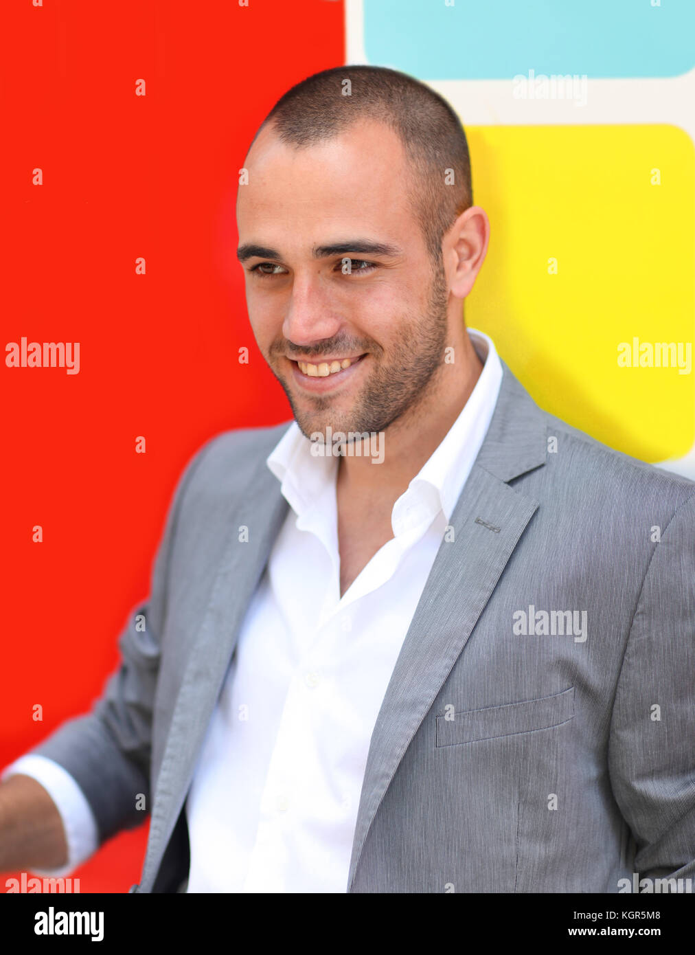 Handsome man standing on colorful wall Stock Photo - Alamy