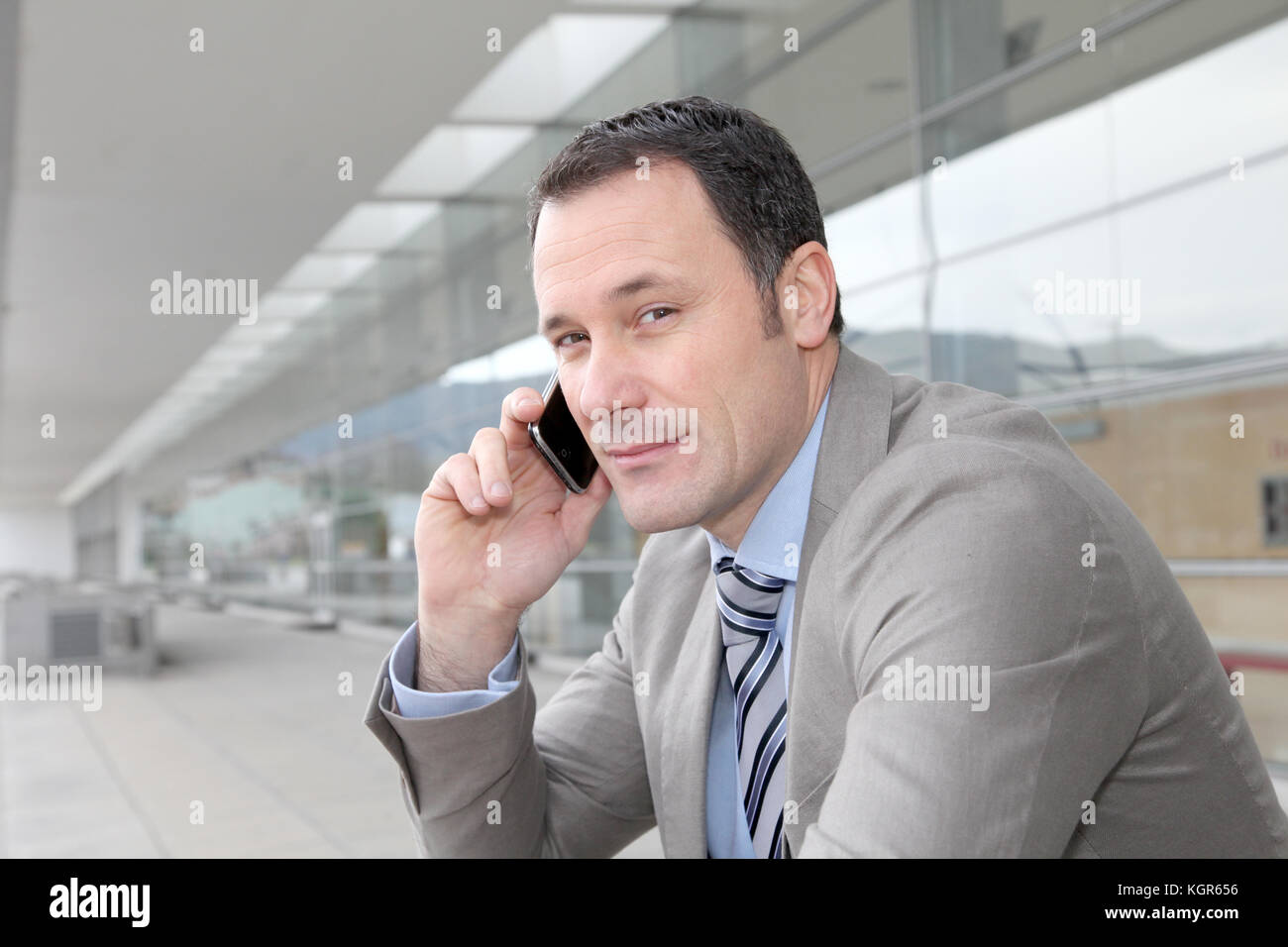 Salesman talking on the phone outside congress center Stock Photo - Alamy