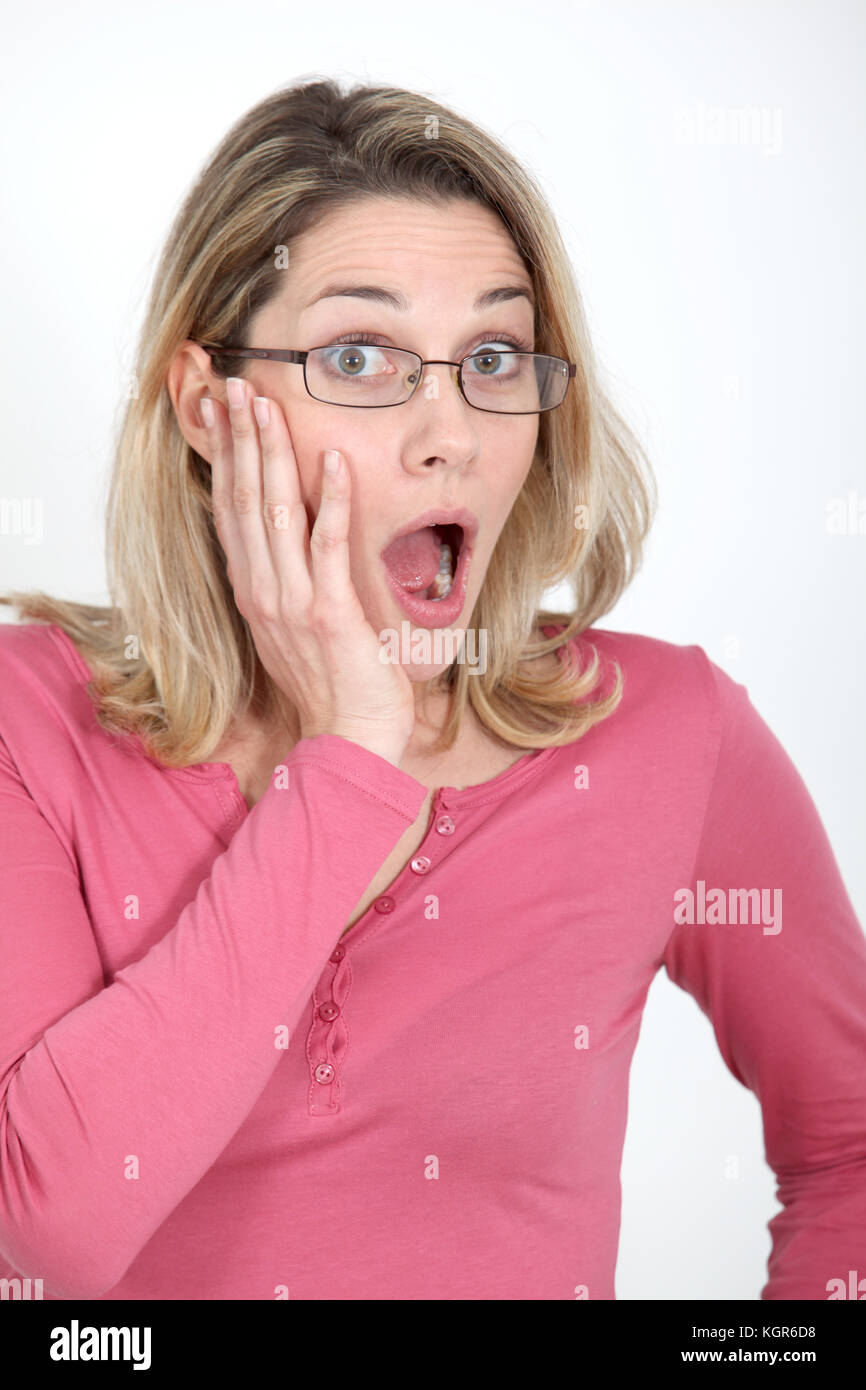 Portrait of blond woman with surprised look Stock Photo - Alamy
