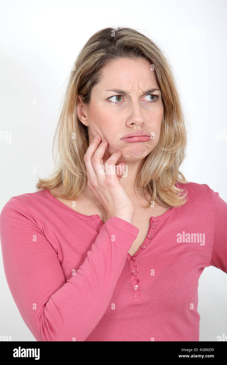 Portrait of blond woman with bored expression Stock Photo - Alamy