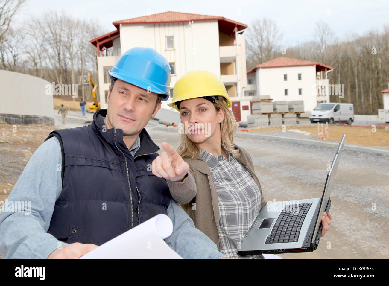 Architect and engineer looking at plan on construction site Stock Photo ...