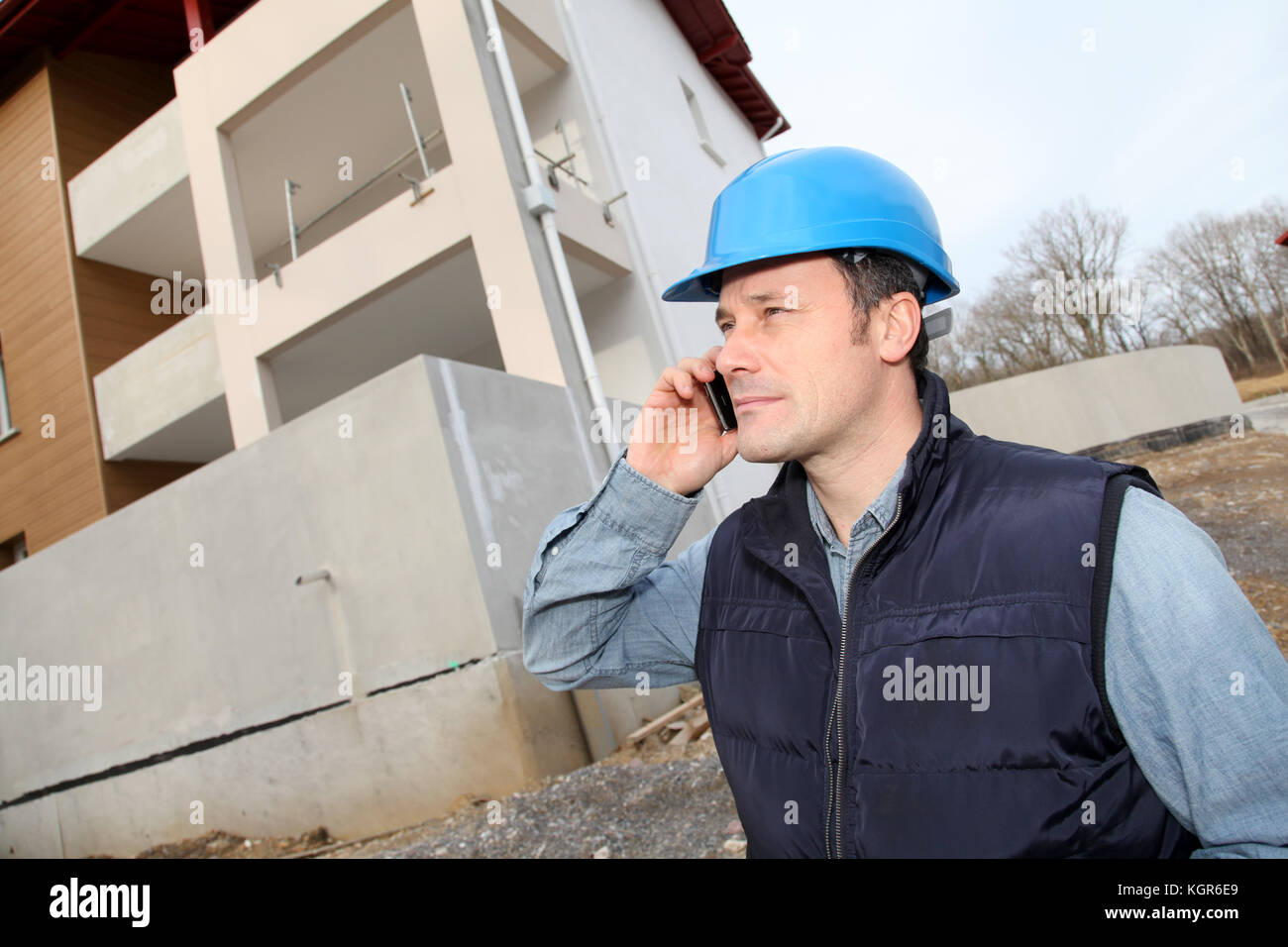 Supervisor talking on the phone on construction site Stock Photo - Alamy