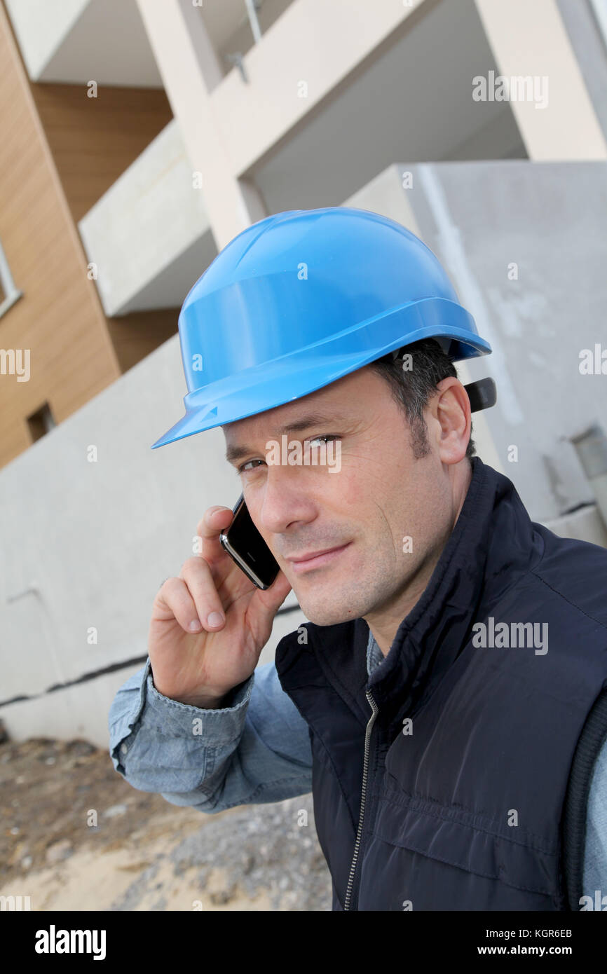 Supervisor talking on the phone on construction site Stock Photo - Alamy