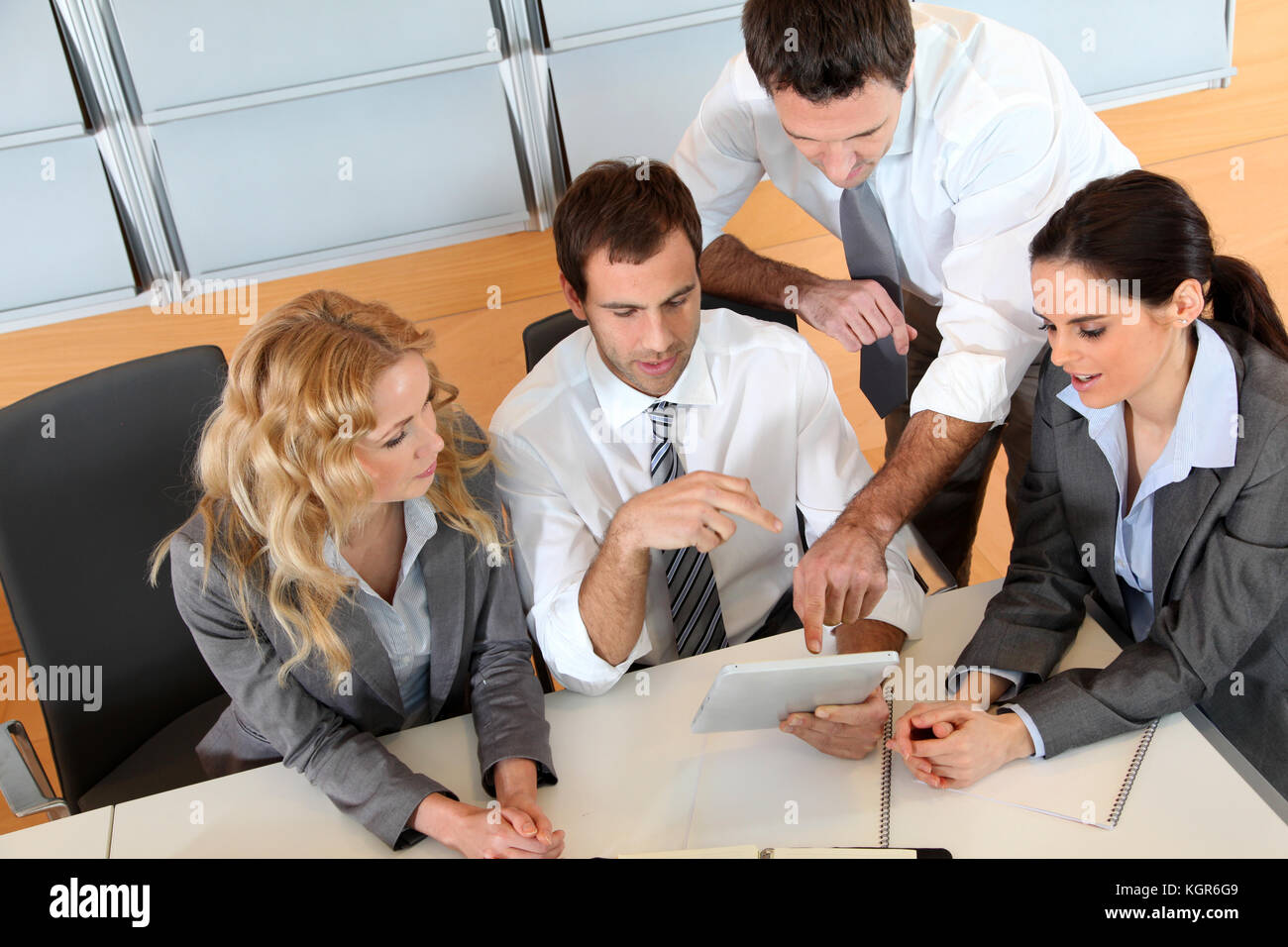 Group of business people meeting around table Stock Photo - Alamy