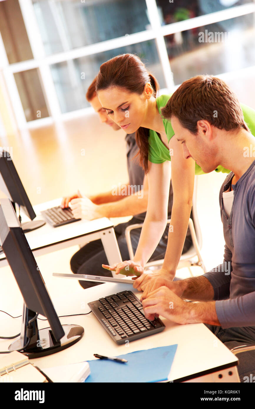 Group of young people working on computer Stock Photo - Alamy
