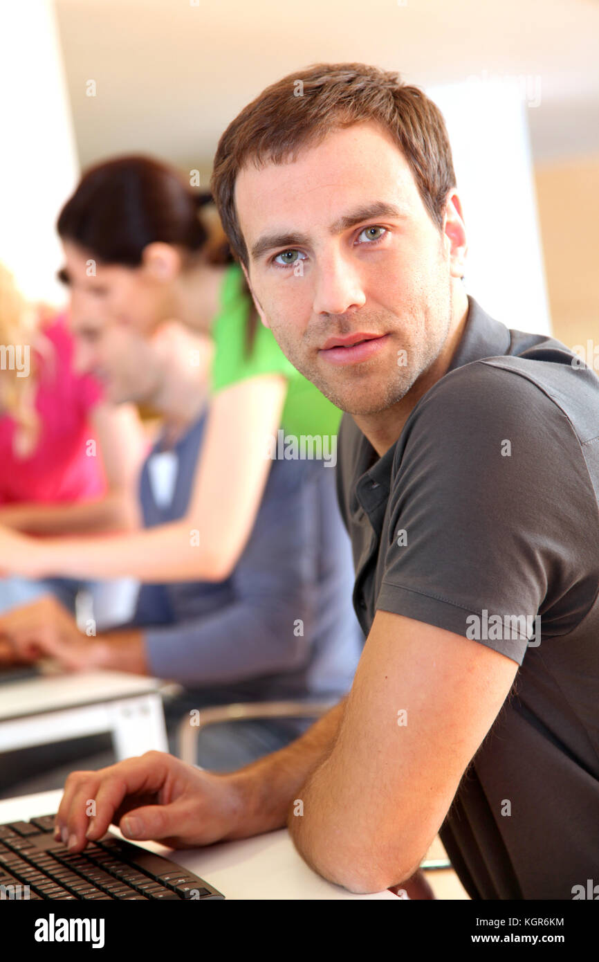 Portrait of young adult attending training class Stock Photo - Alamy