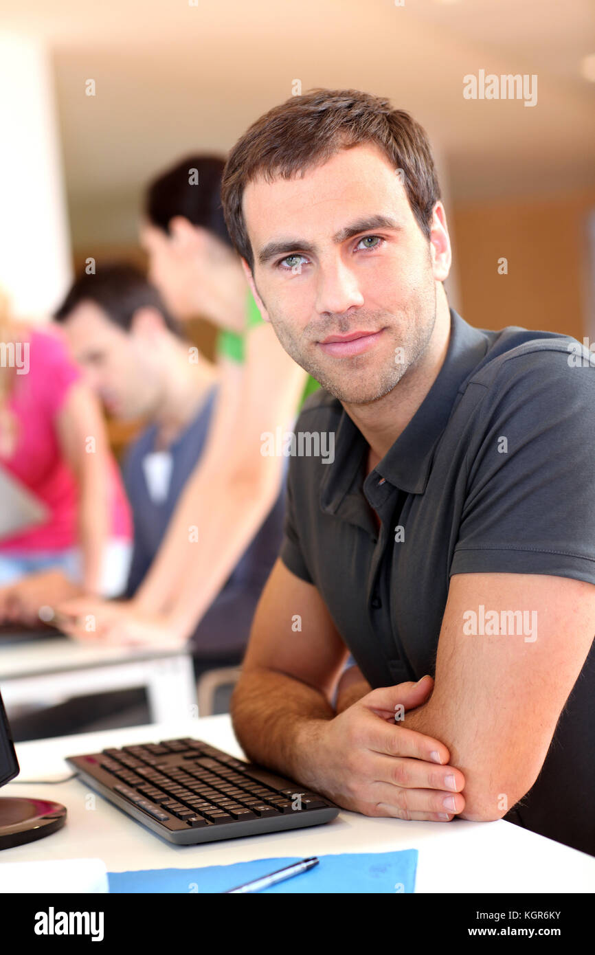 Portrait of young adult attending training class Stock Photo - Alamy