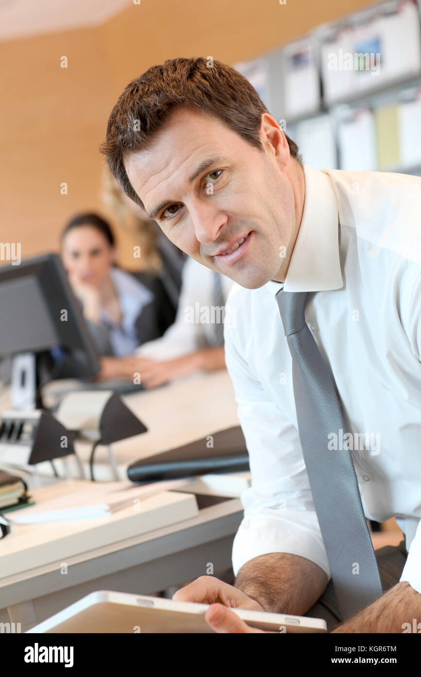 Portrait of business manager using electronic tablet Stock Photo - Alamy