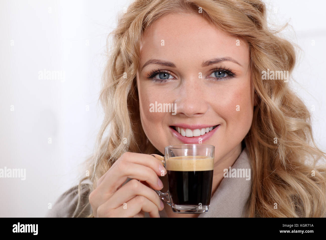 Portrait of blond woman drinking expresso Stock Photo - Alamy