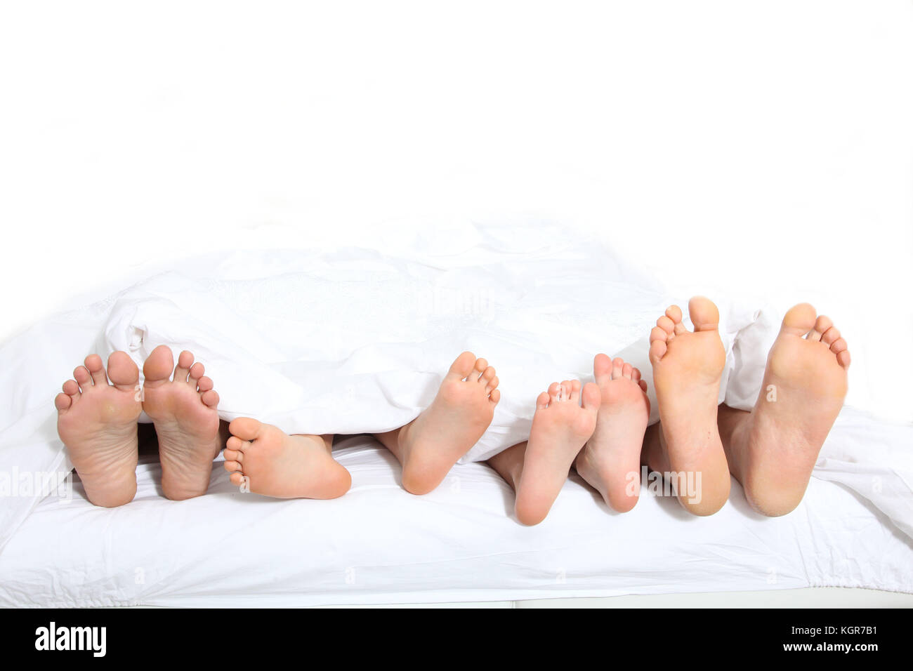Closeup of family feet in bed Stock Photo - Alamy