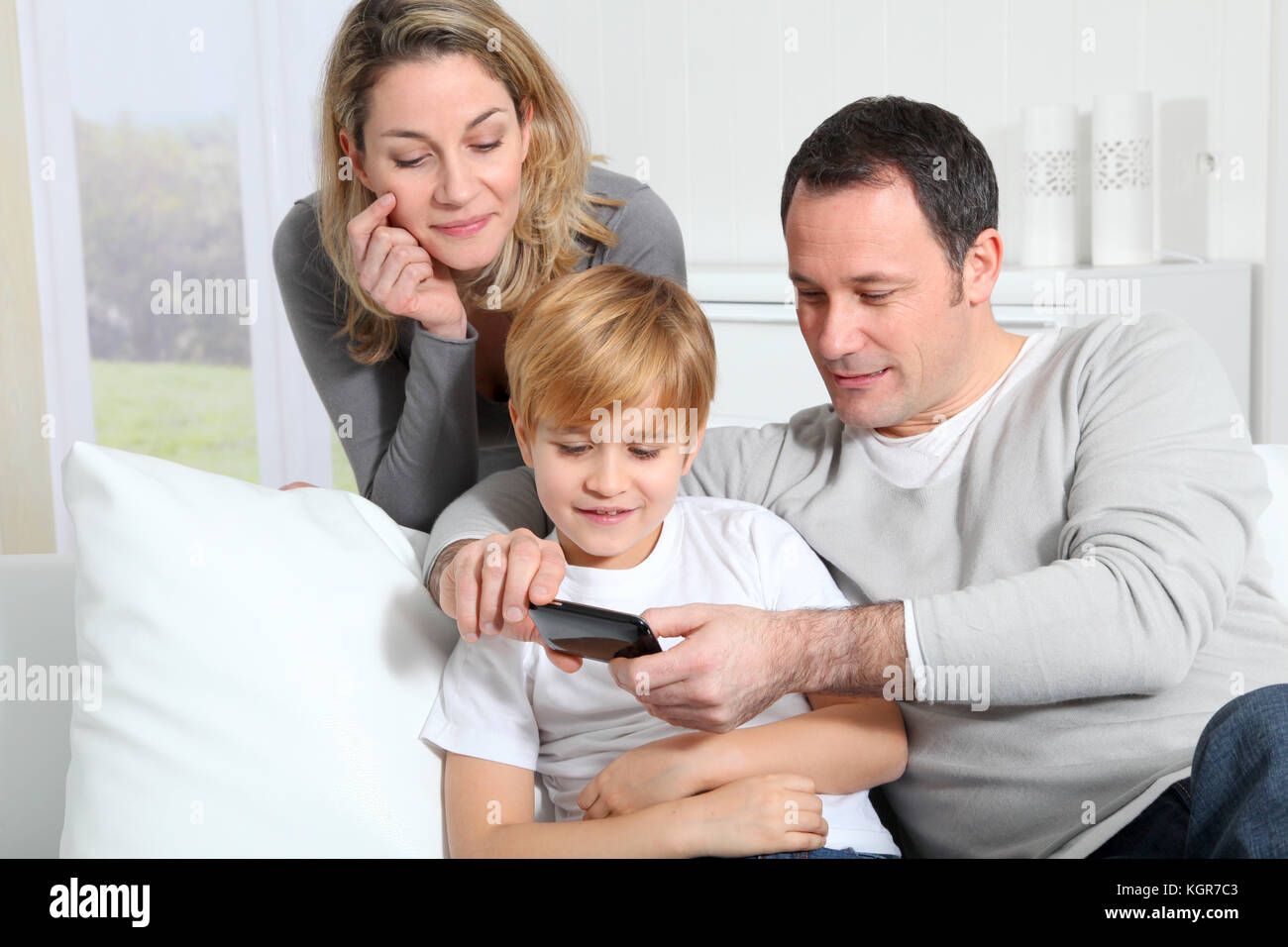 Family playing video game on smartphone Stock Photo - Alamy