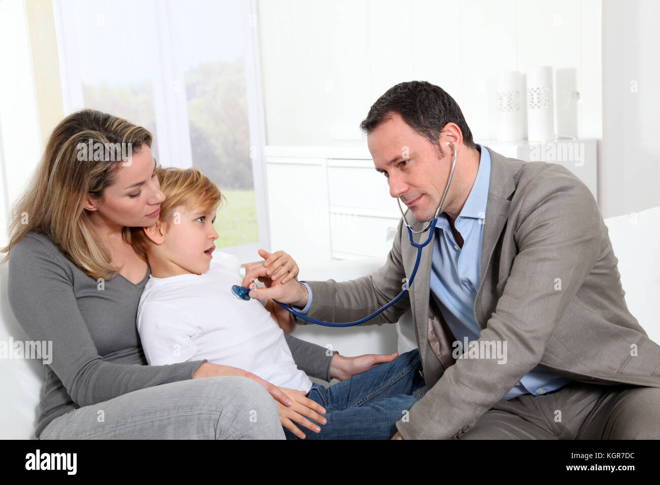 Doctor examining sick little boy Stock Photo - Alamy