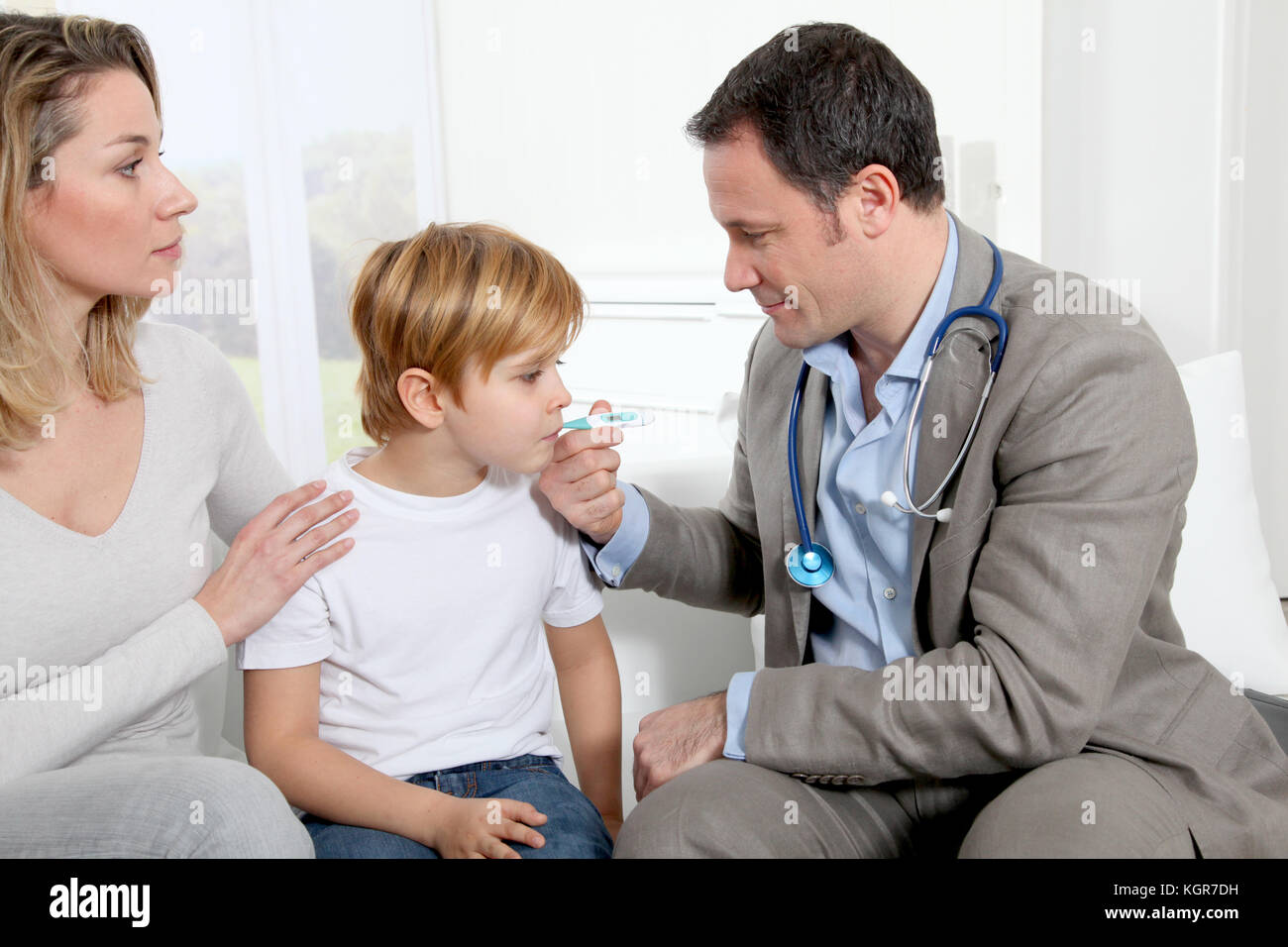 Doctor taking little boy's temperature Stock Photo - Alamy