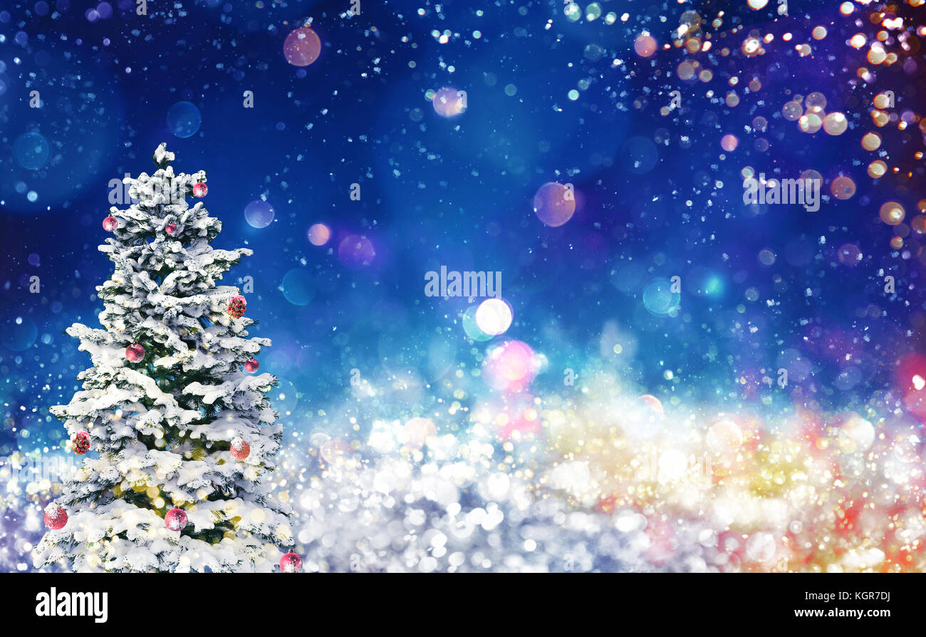 Christmas tree on a blue sparkly night sky Stock Photo - Alamy