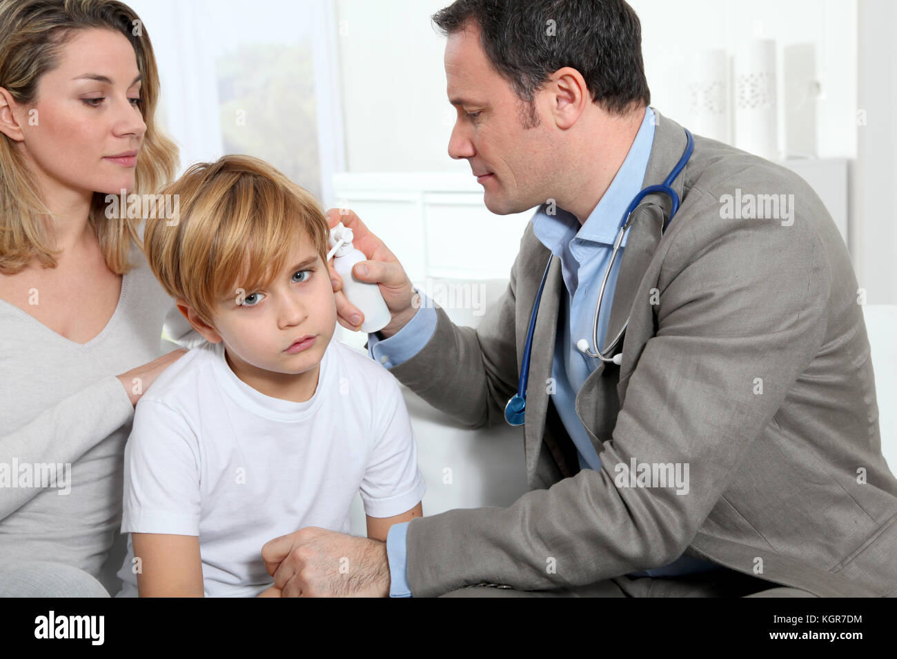 Doctor cheking little boy's ear infection Stock Photo - Alamy