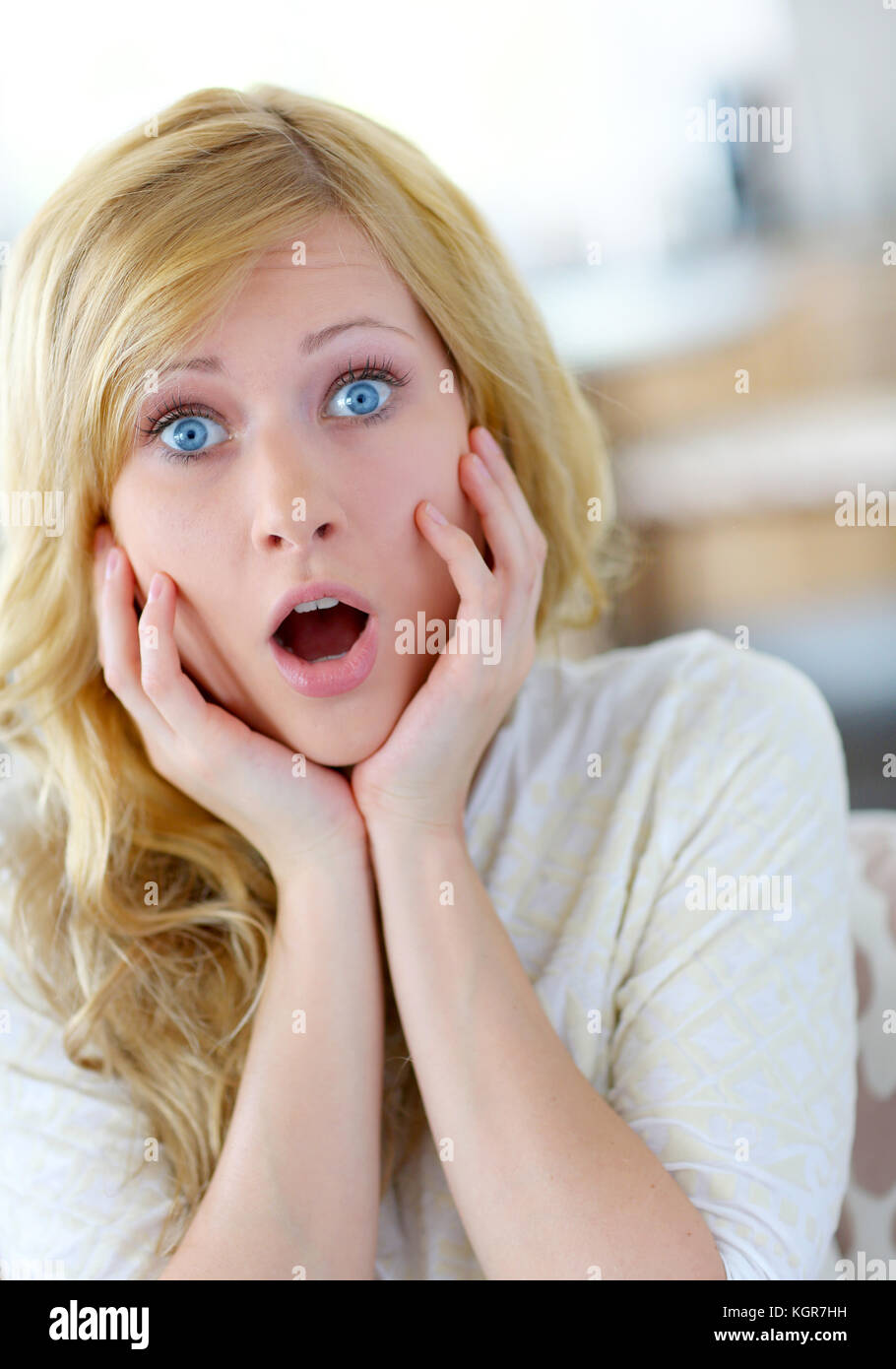 Blond woman with surprised look on her face Stock Photo - Alamy