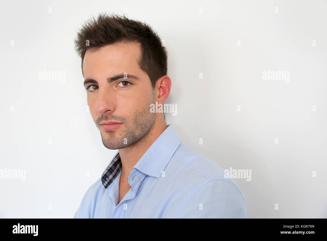 Serious young man standing on white background Stock Photo - Alamy