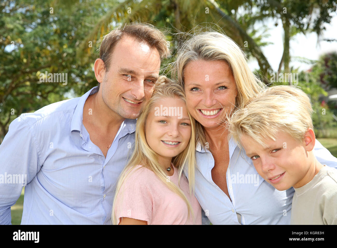 Portrait of happy family standing outside Stock Photo - Alamy