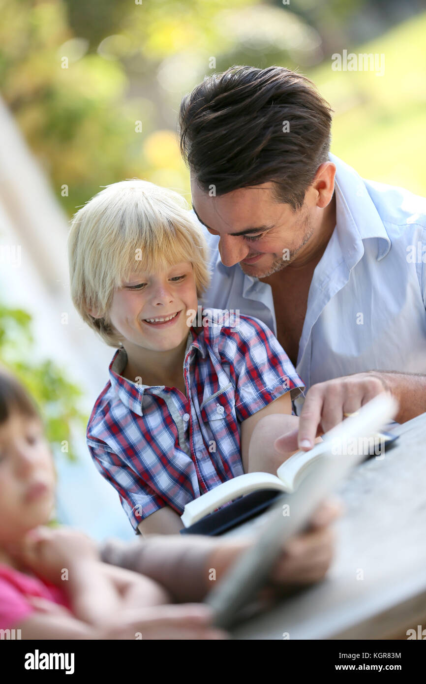 Father reading to son outdoors hi-res stock photography and images - Alamy