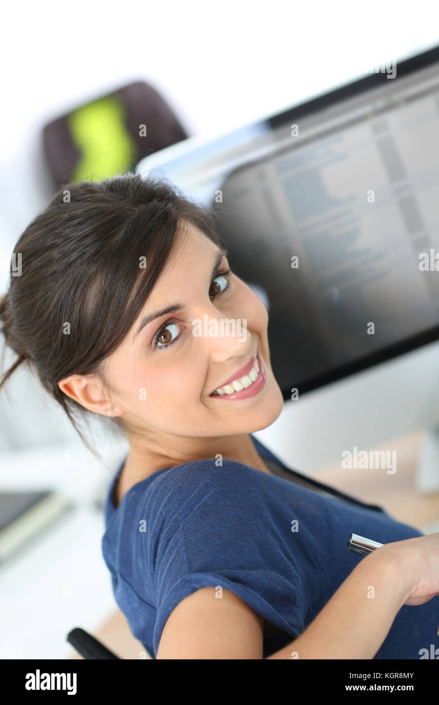 Smiling brunette girl in training class Stock Photo - Alamy