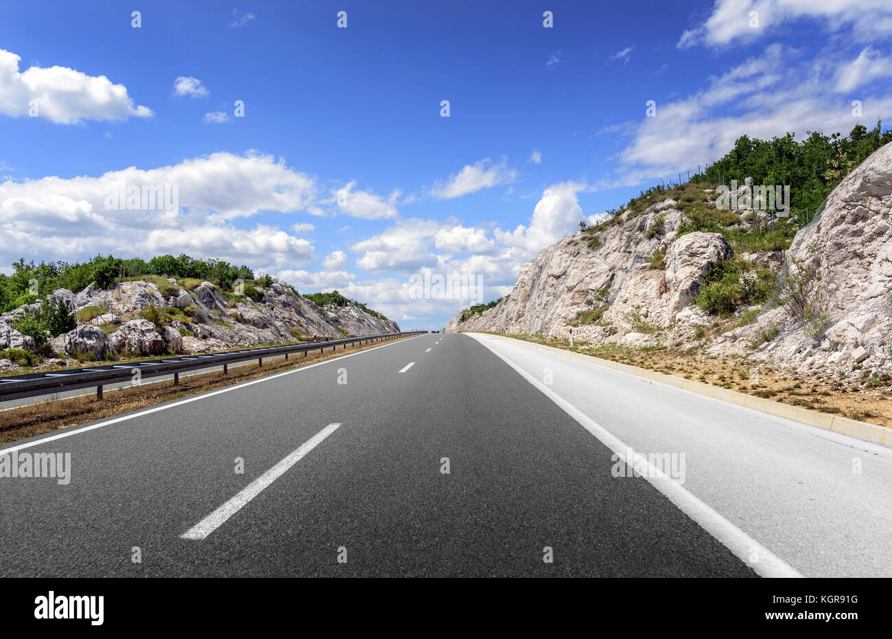 High-speed country road among the mountains Stock Photo - Alamy