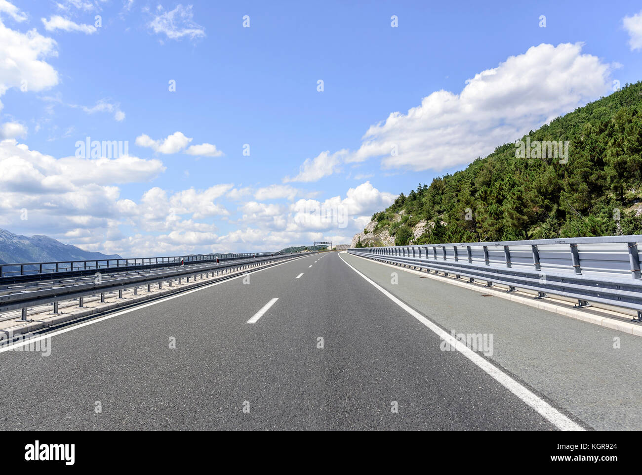High-speed country road among the mountains Stock Photo - Alamy