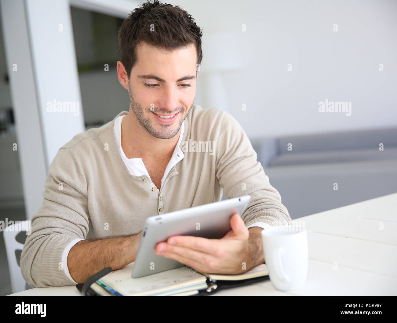 Man working from home on digital tablet Stock Photo - Alamy